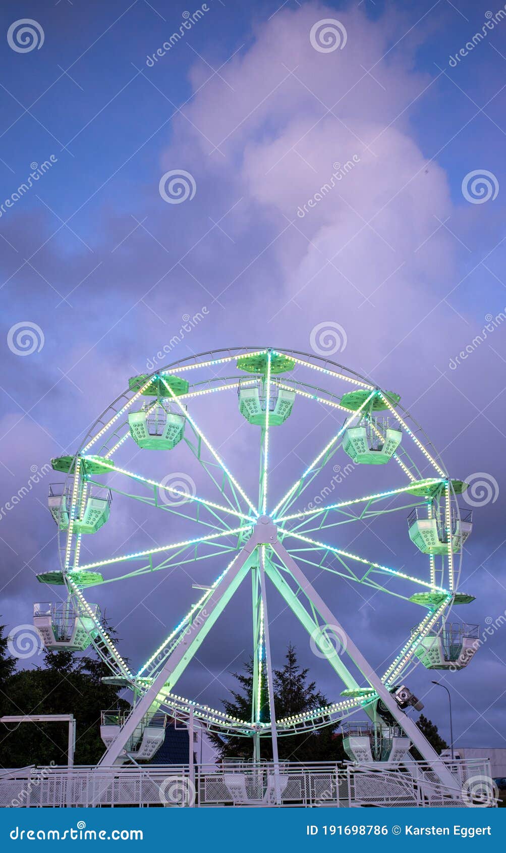 A Colourfully Illuminated Ferris Wheel Stands in Front of a Dark Sky ...