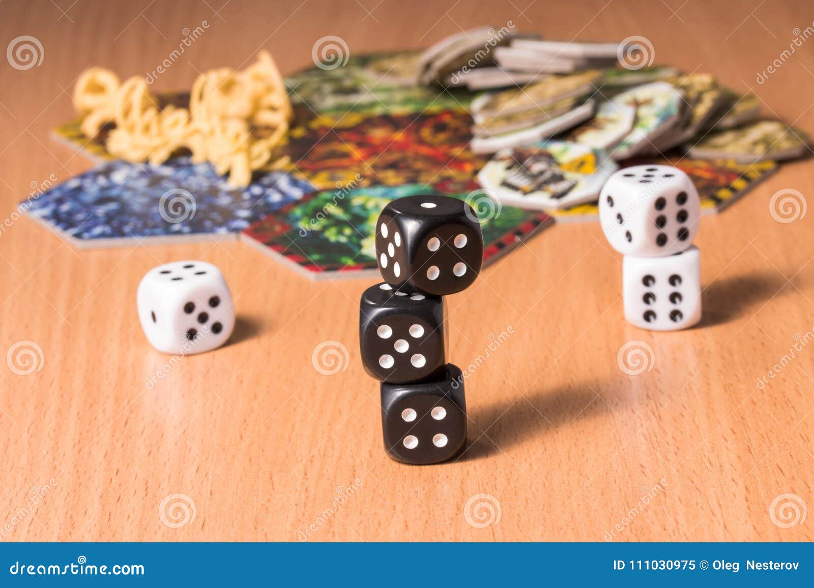 Column of Black Dice on a Blurred Background of White and Other Objects ...