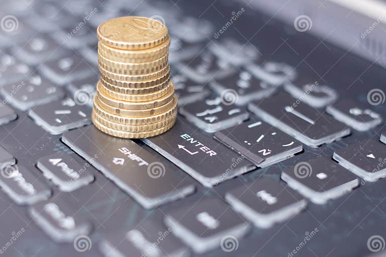 A Column of Coins on a Computer Keyboard. Stock Image - Image of enter ...