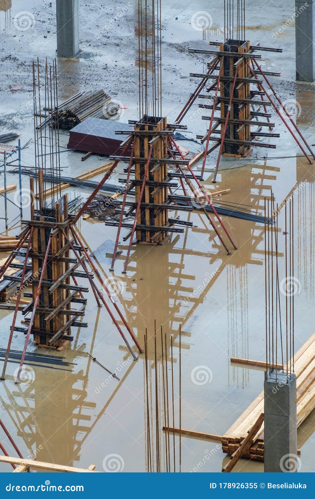 Columns Reflecting on the Puddle at Construction Site Stock Image ...