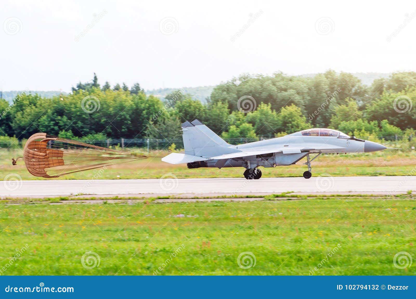 Combat Fighter after Landing on the Runway with the Released Parachute ...