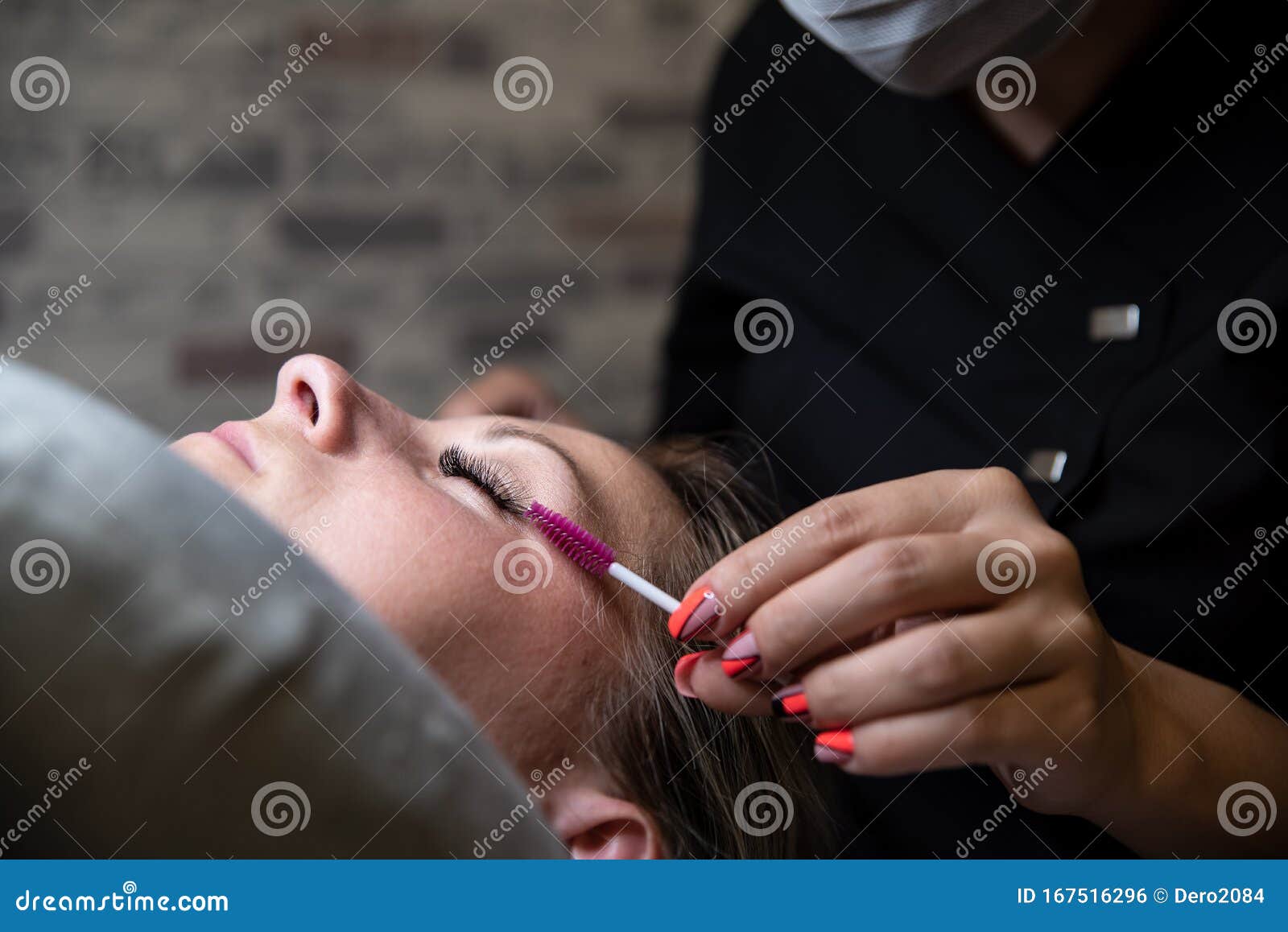 Combing Eyelashes of Young Woman Using Disposable Eyelash Mini Brush ...