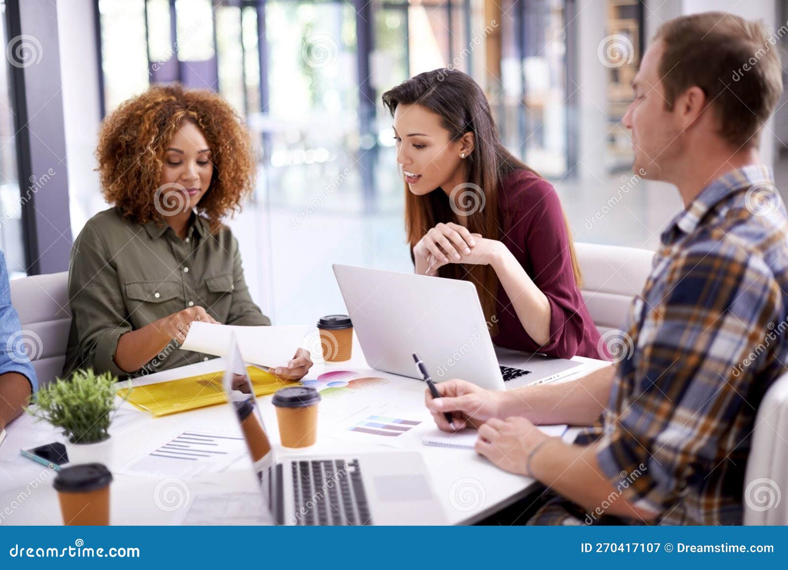 Combining Their Creative Know-how. a Team of Designers Having a Meeting ...