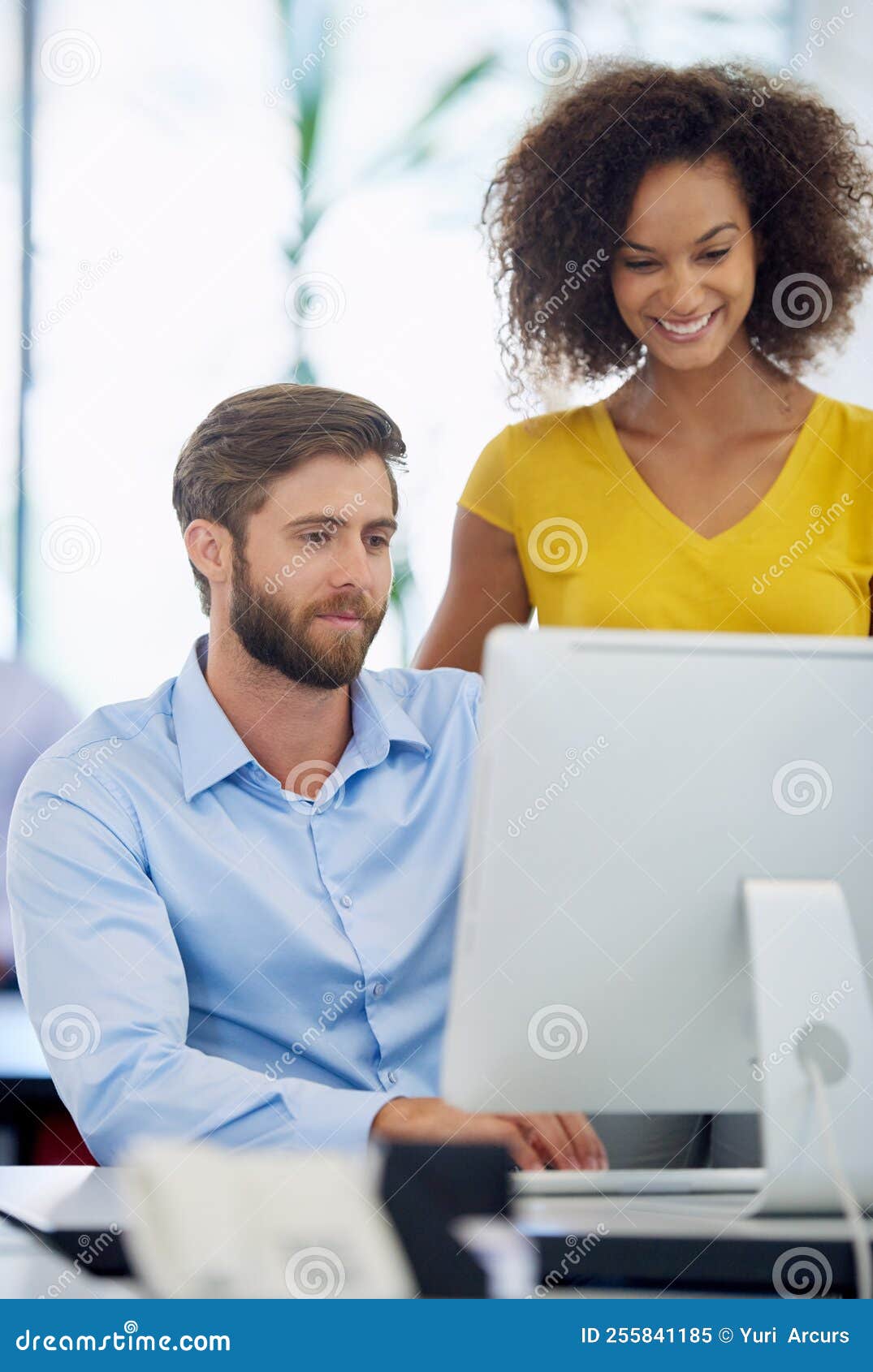 Combining Their Expertise. Two Young Colleagues Working Together at a ...