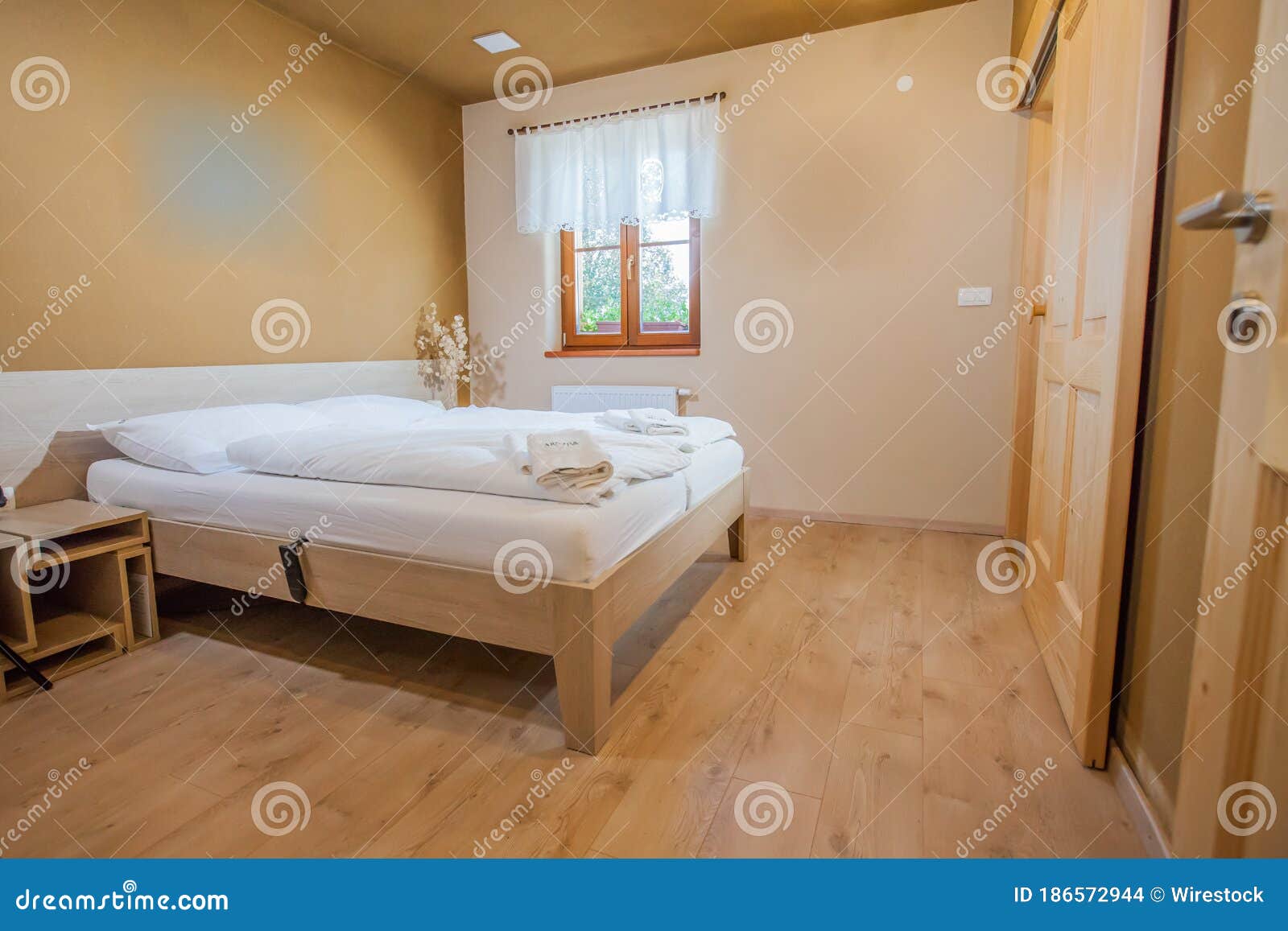 Comfortable Rustic Hotel Room with White Bed Linen at a Nature Park ...