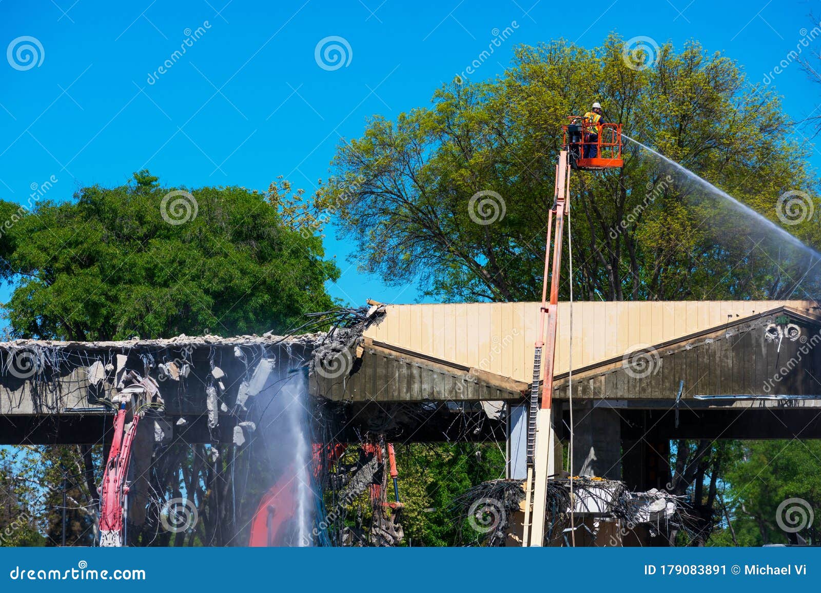 Commercial Building Demolition in Progress. Construction Workers Dampen ...