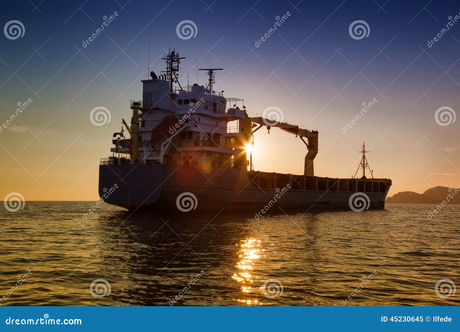 Commercial Cargo Ship at Sunset Stock Image - Image of sailing, sunrise ...