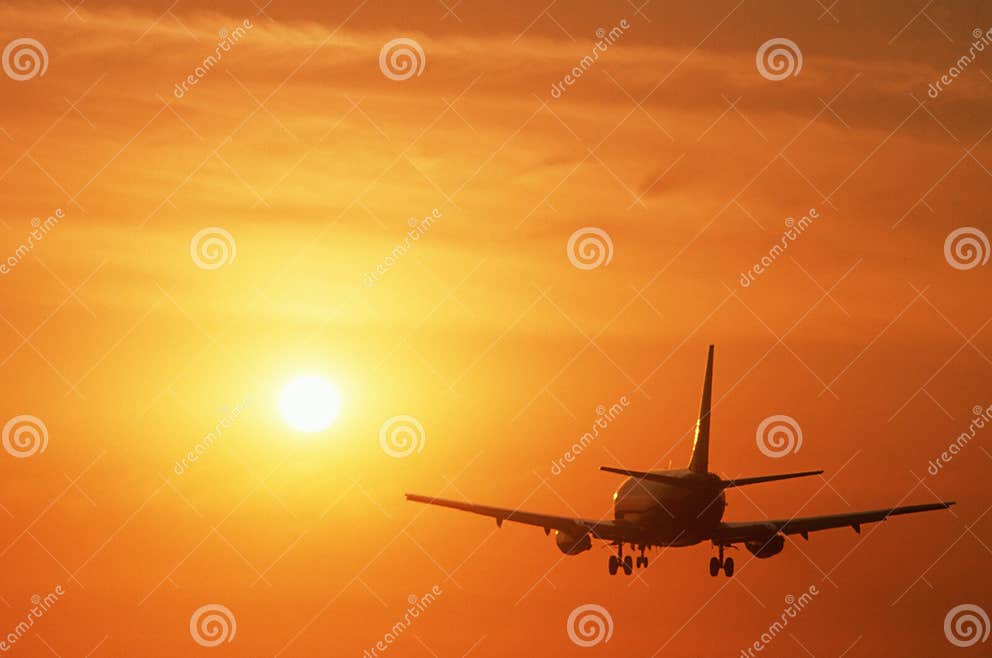 Commercial Jet Flying into Sunset Stock Photo - Image of engine ...