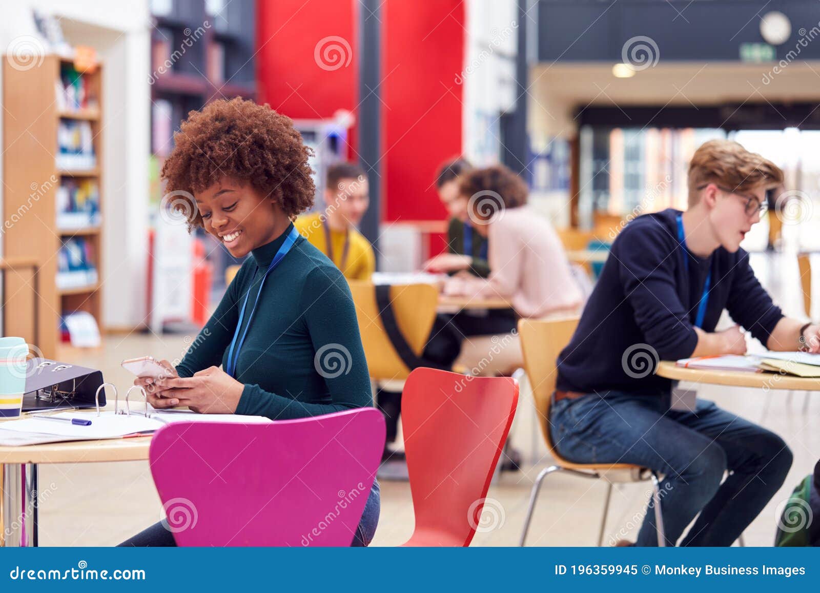 Communal Area of Busy College Campus with Students Working at Tables ...
