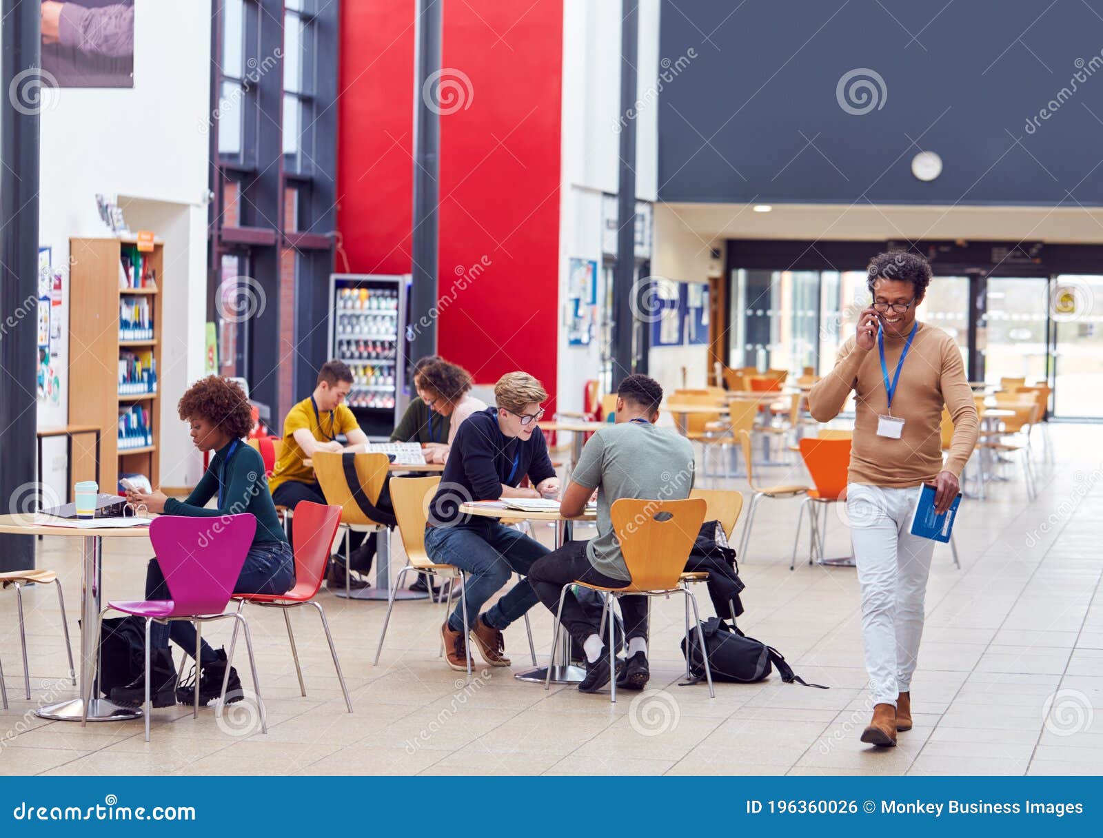 Communal Area of Busy College Campus with Students Working at Tables ...