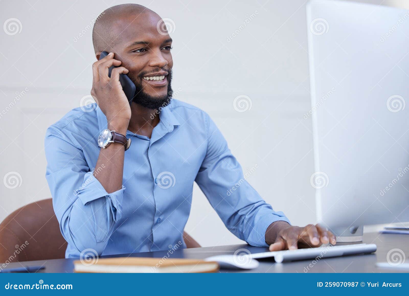 Communicating on All Platforms. a Young Businessman Using a Computer ...