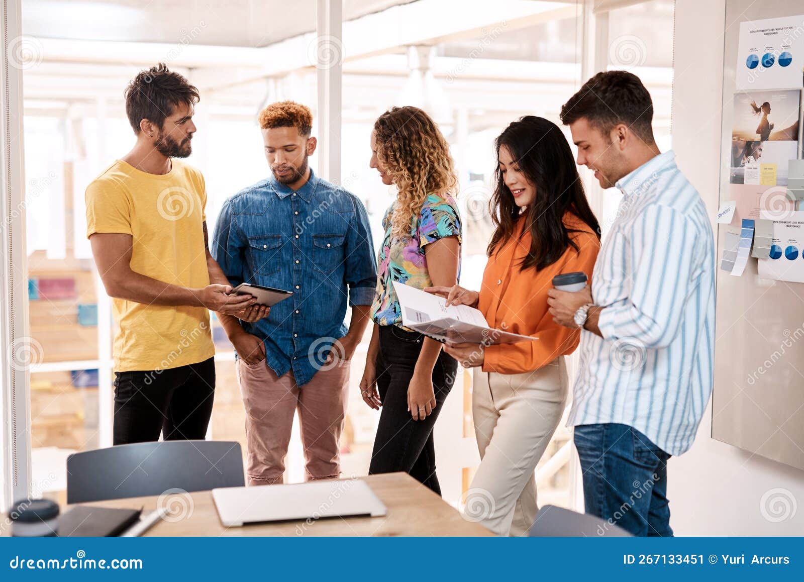 Always Communicating. a Group of Young Designers Having a Discussion ...