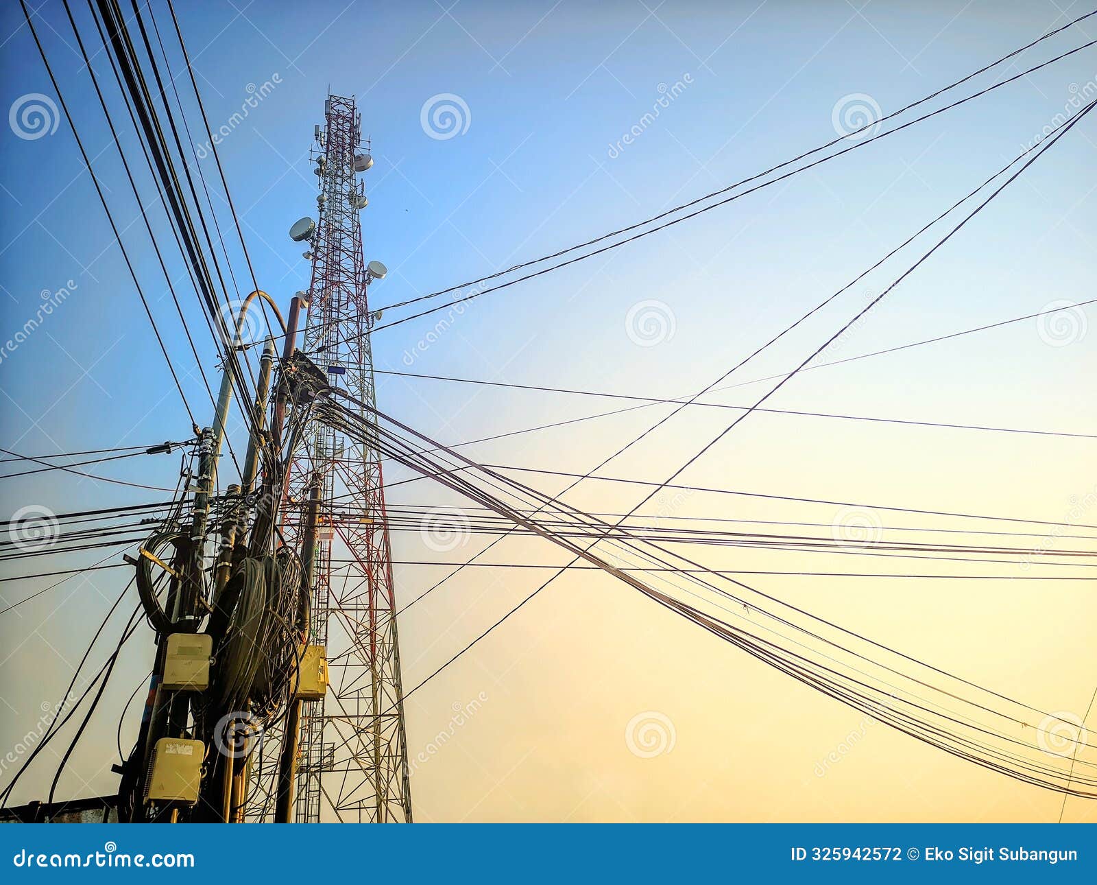 A Communications Tower with Antennas Soaring into the Blue Sky, with ...