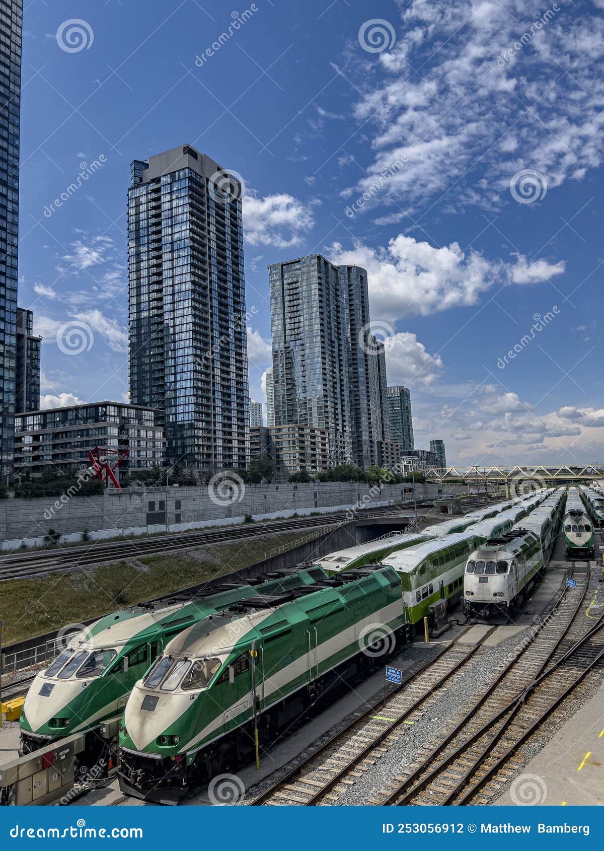 Commuter Trains on Tracks with Buildings in Background Stock Photo ...