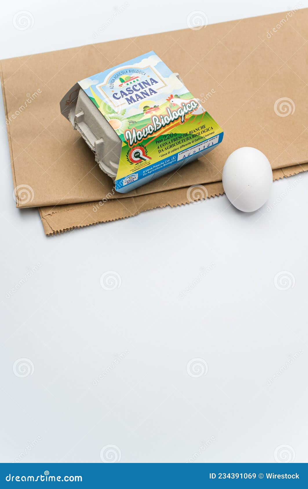 Cardboard Egg Box and White Fresh Eggs on a White Tabletop Backg ...