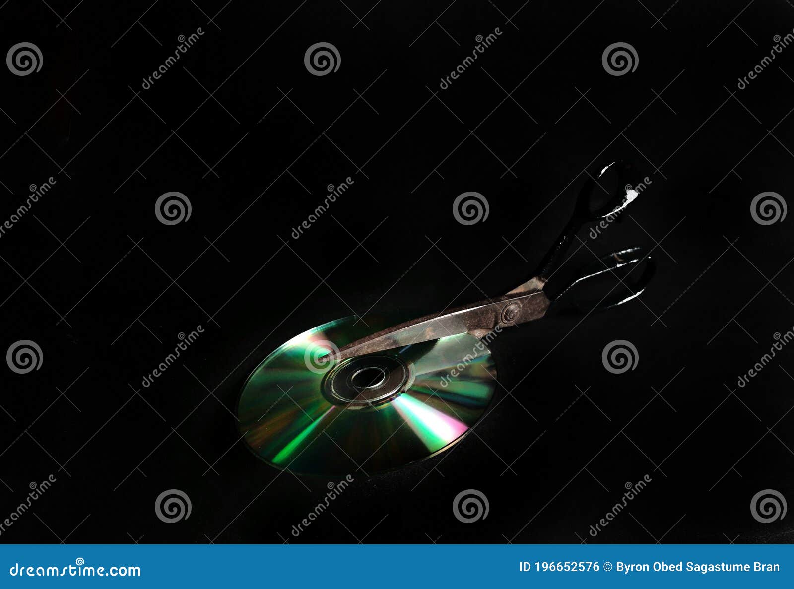 Compact Disk Cut by Scissors on Black Background. Obsolete Technology ...