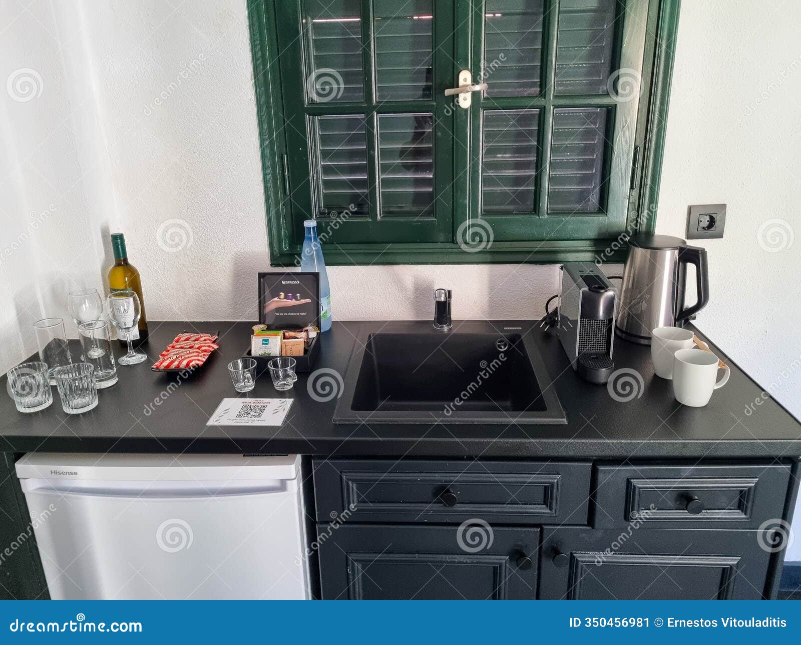 Compact Kitchenette Setup with Coffee Machine, Sink, and Assorted ...