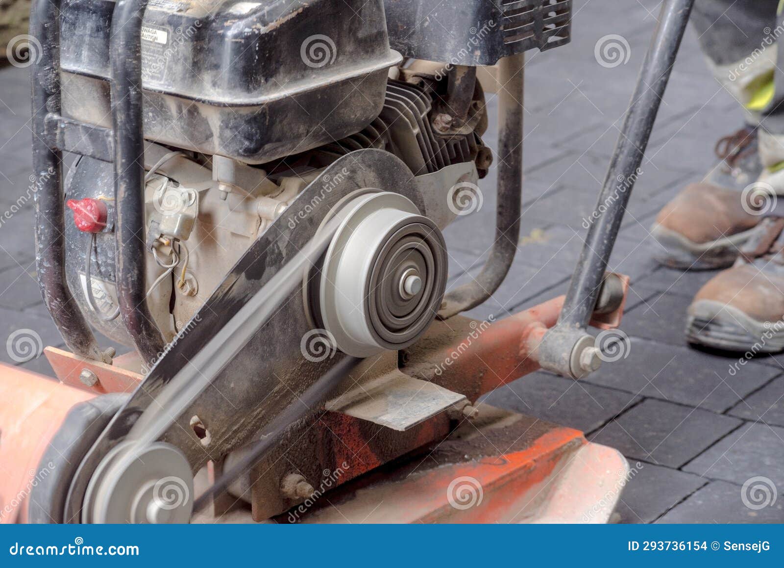A Worn-out Orange Paving Compactor without a Gear Cover Levels the ...