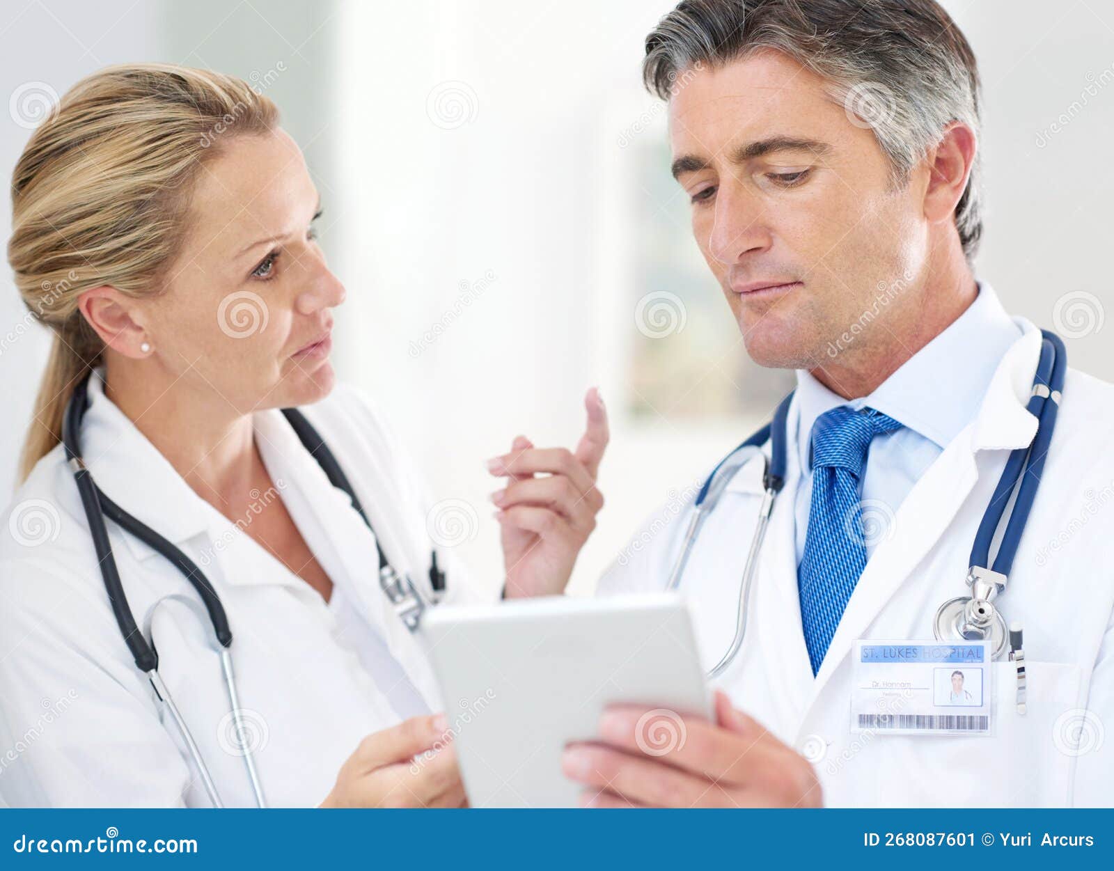 Comparing Medical Notes. Two Doctors Talking Together Over a Digital ...