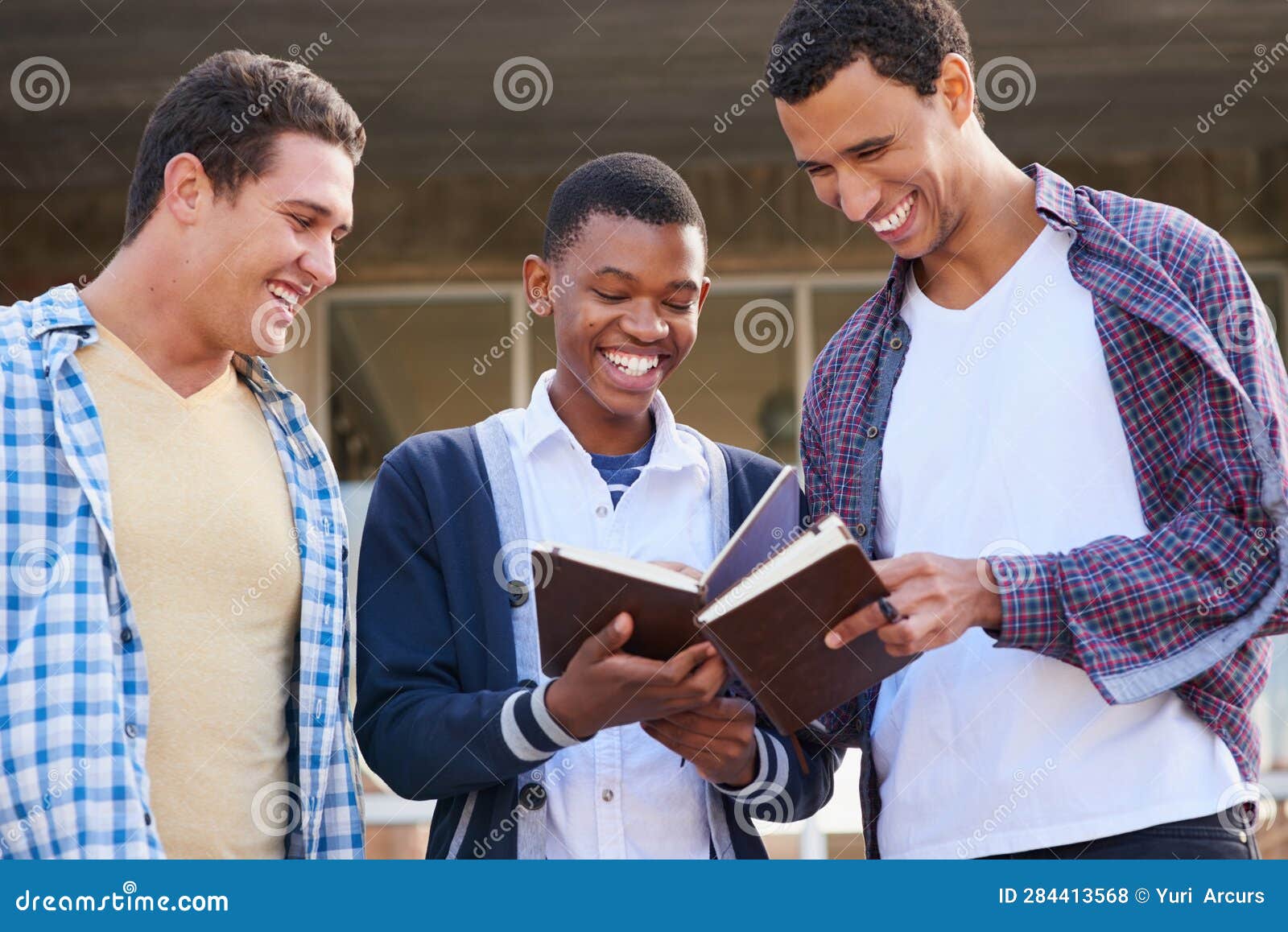 Comparing Notes. Cropped Shot of a Group of University Students Looking ...