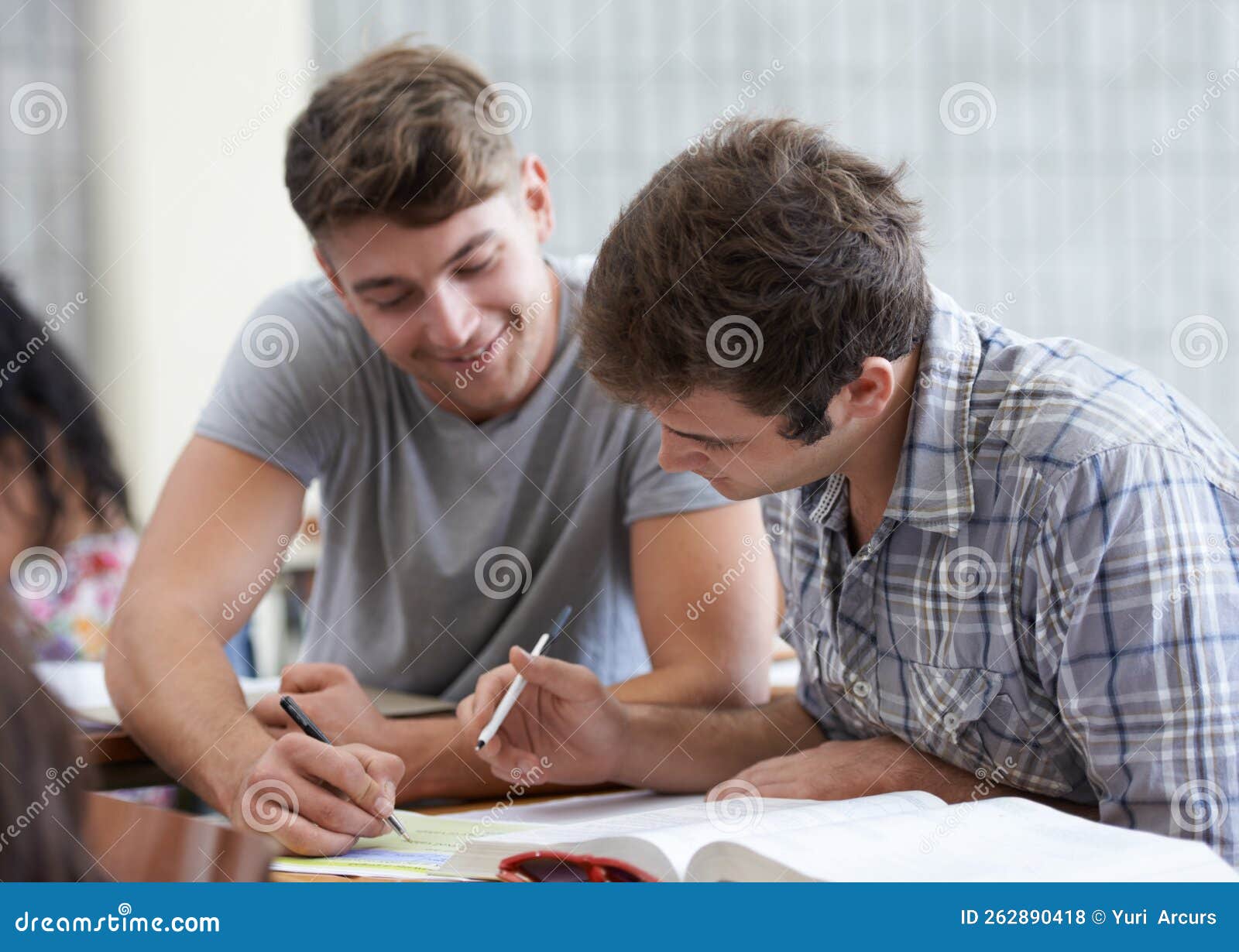 Comparing Their Assignment Notes. a University Students Studying in ...