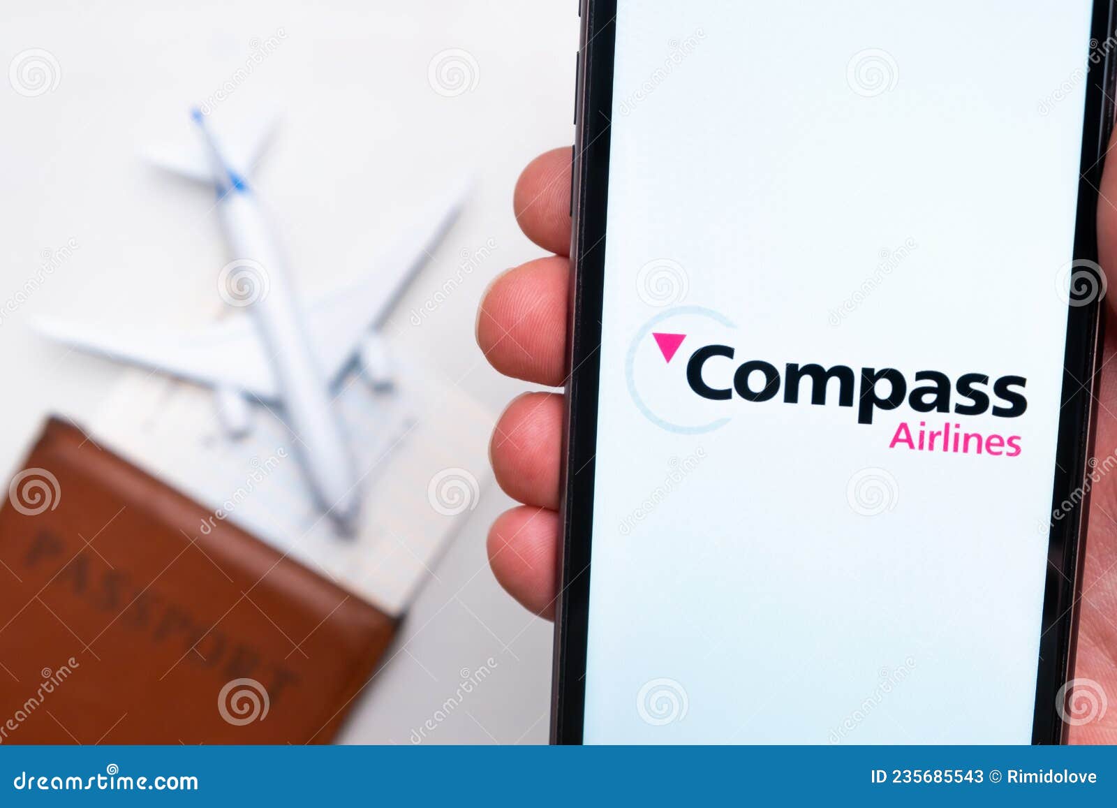 Compass Airlines App Logo on the Screen of Mobile Phone. a Blurry Image ...