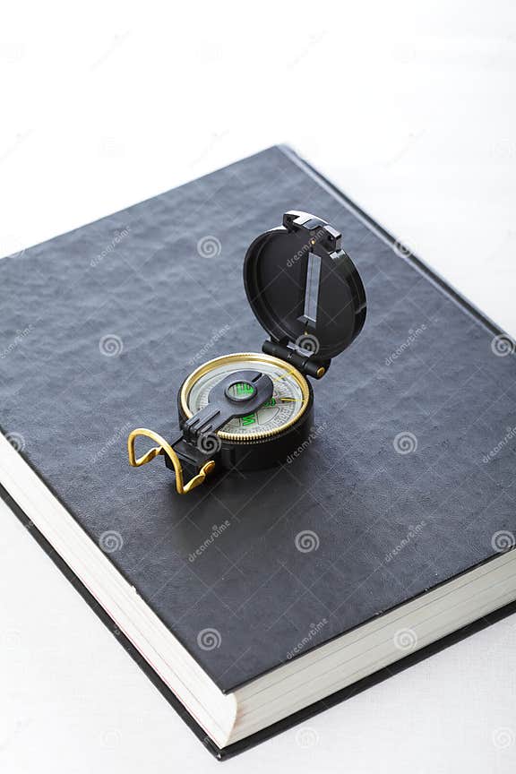Compass on book stock image. Image of life, direction - 17739853
