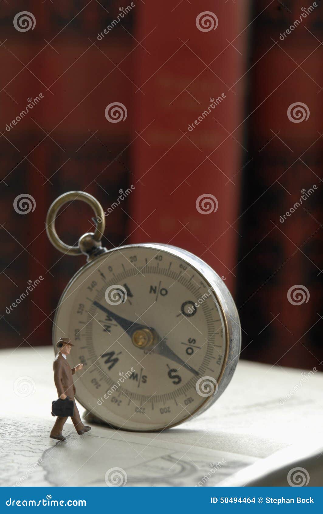Compass and Figurine on Book Stock Photo - Image of standing, likeness ...