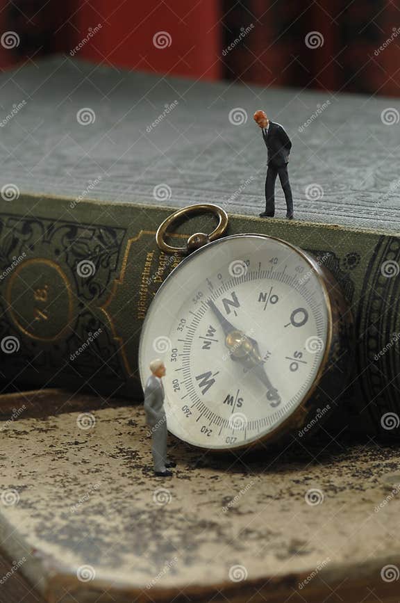 Compass with Figurine and Book, Close Up Stock Photo - Image of ...