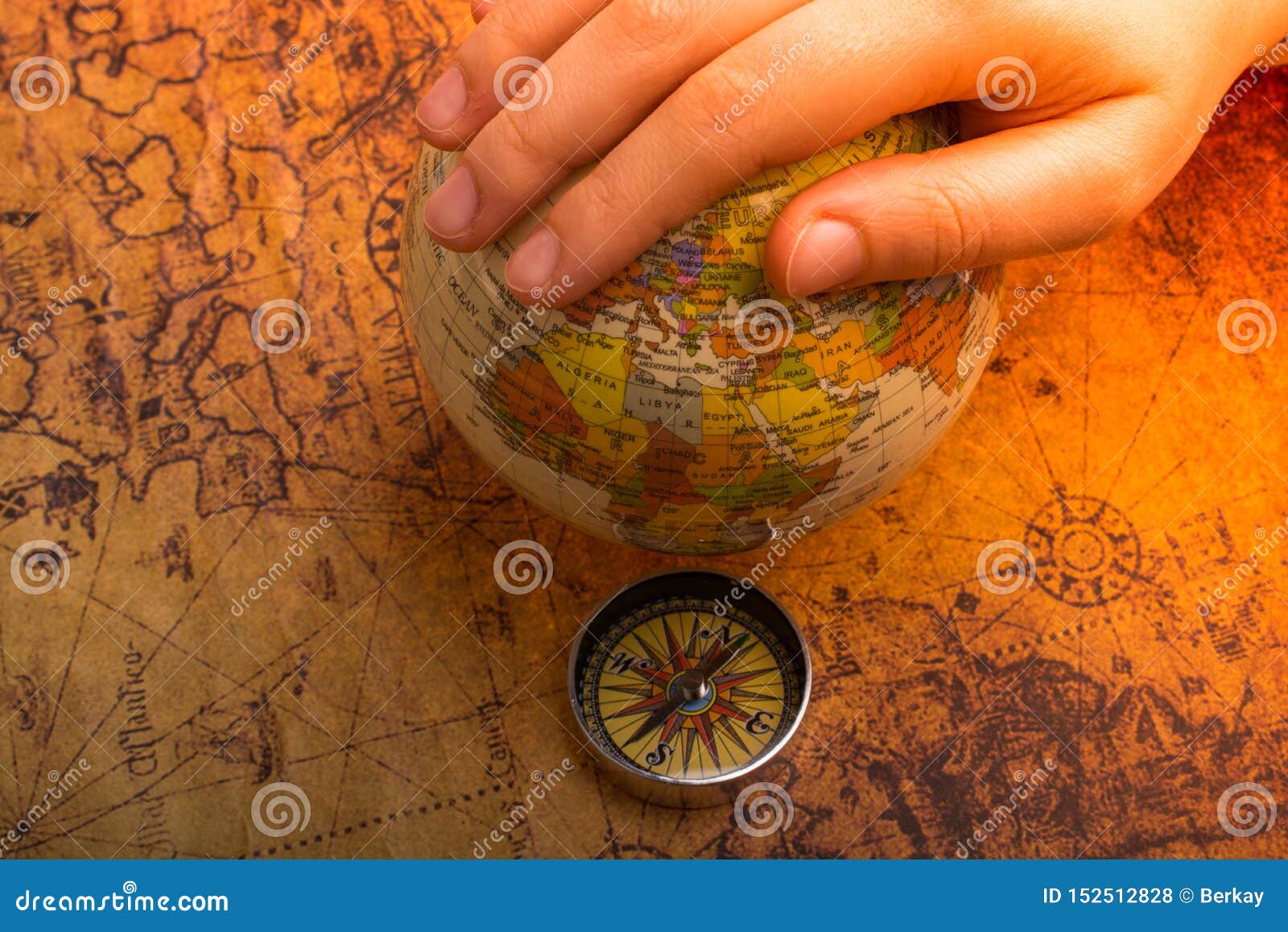 Compass beside a Globe Under Hand As a Concept of Traveling Stock Photo ...