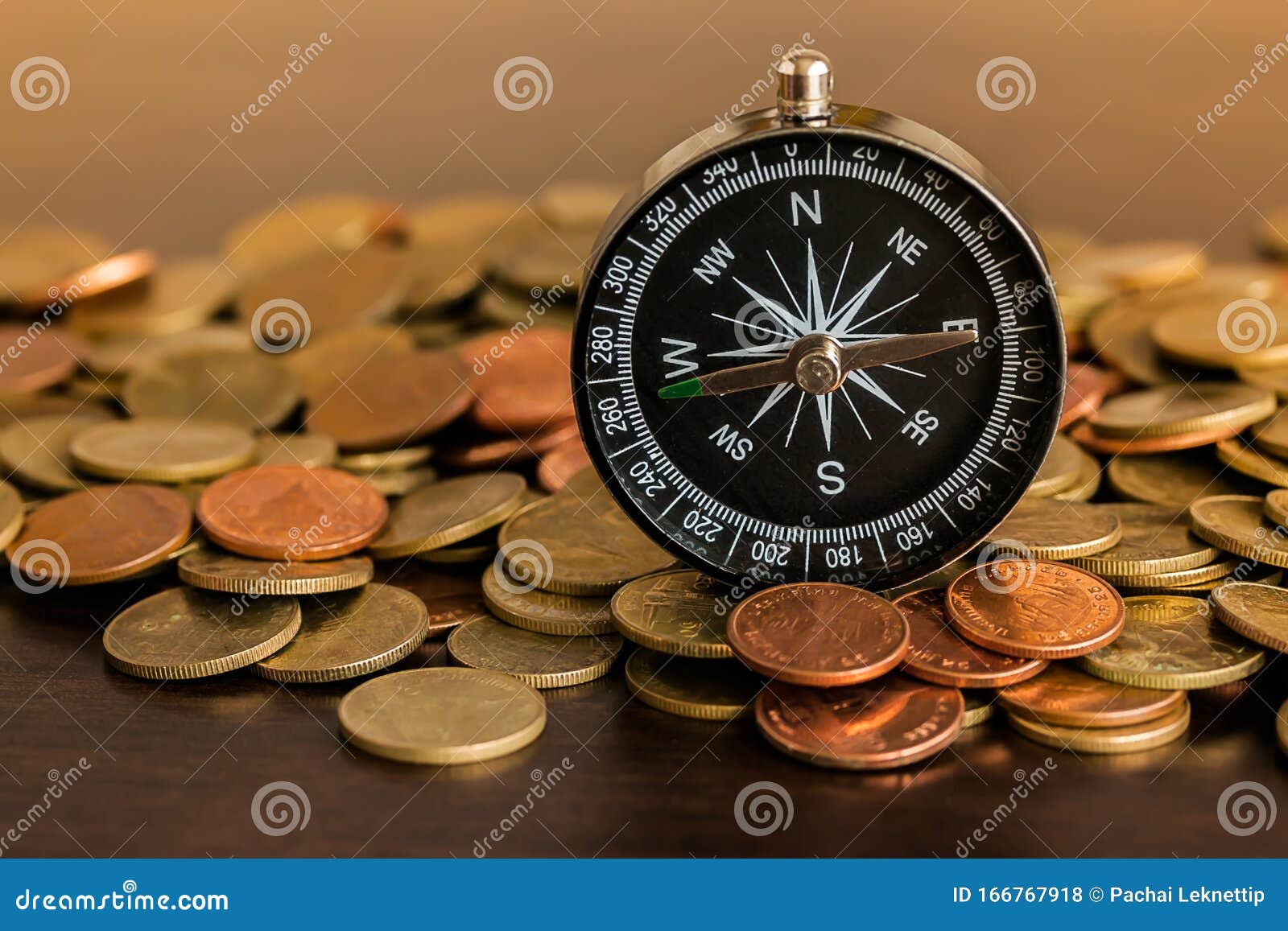 Compass on group of coins stock photo. Image of management - 166767918