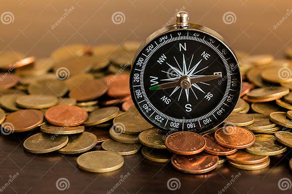 Compass on group of coins stock photo. Image of management - 166767918