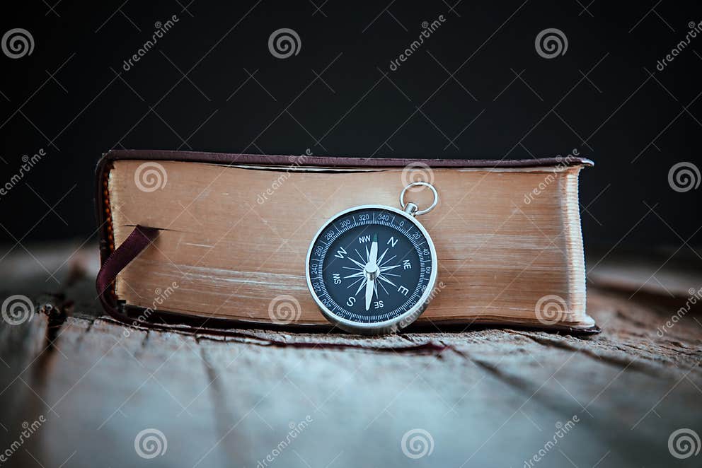 Compass with Holy Bible stock photo. Image of book, world - 220415566