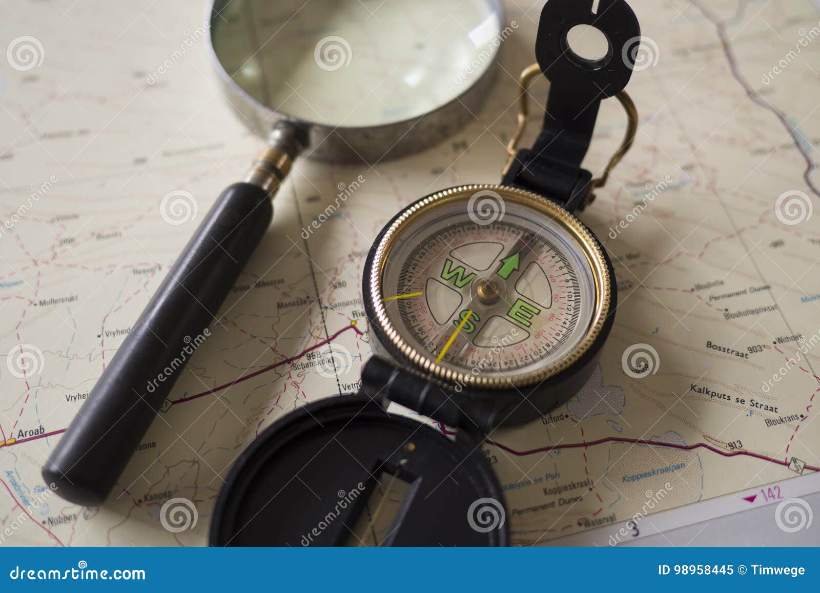 Compass and Magnifying Glass on a Map Stock Image - Image of ...