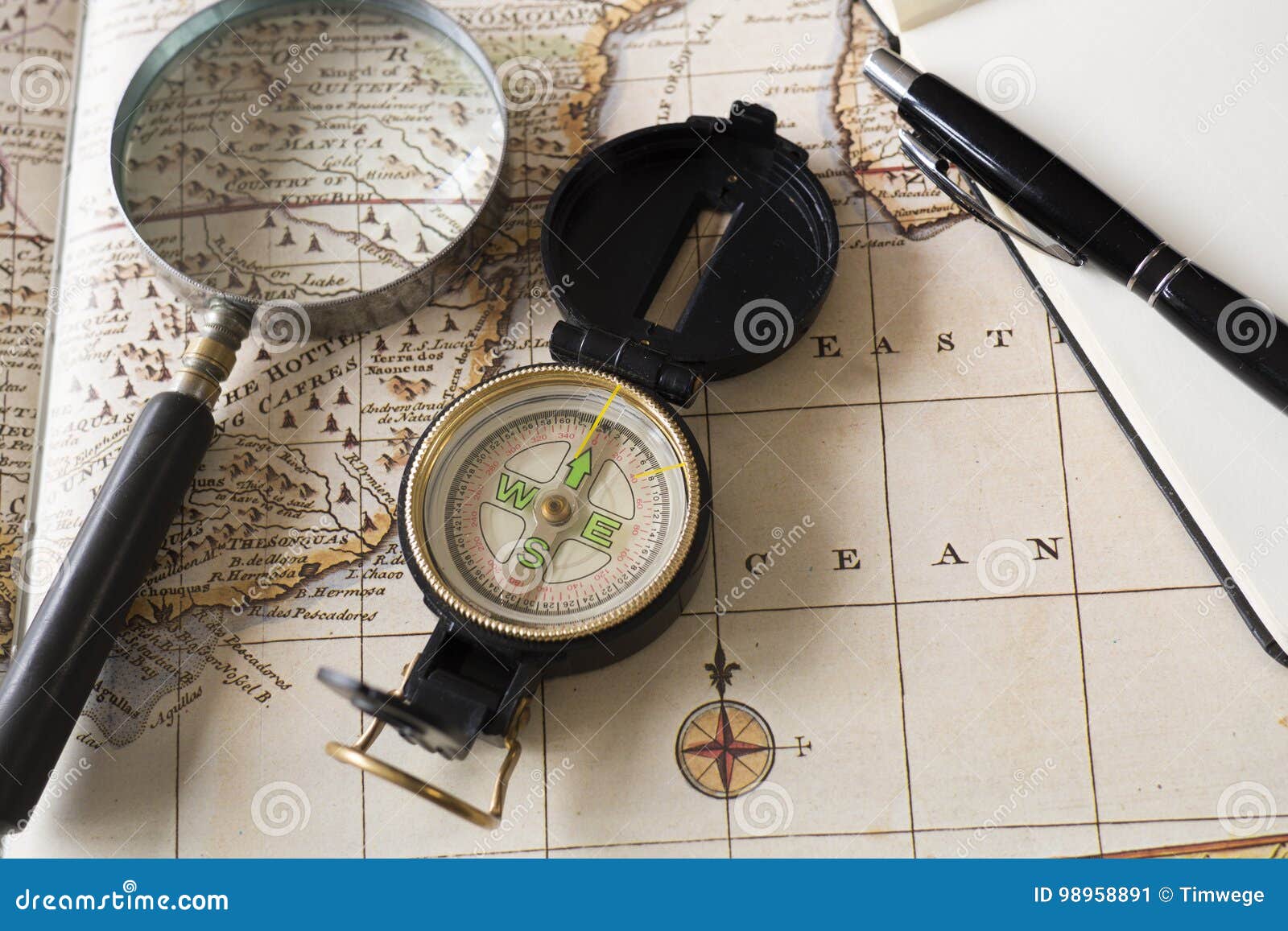 Compass and Magnifying Glass on Top of Old Map Stock Image - Image of ...