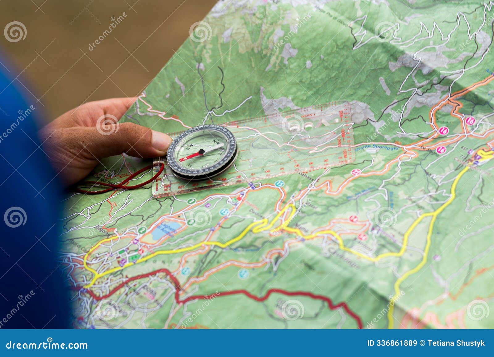 Compass and Map in Hands of Traveler for Checking and Searching ...