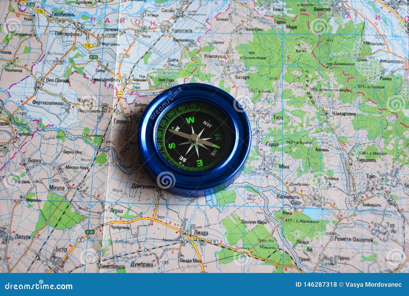 Compass on the map stock photo. Image of unfolded, photograph - 146287318