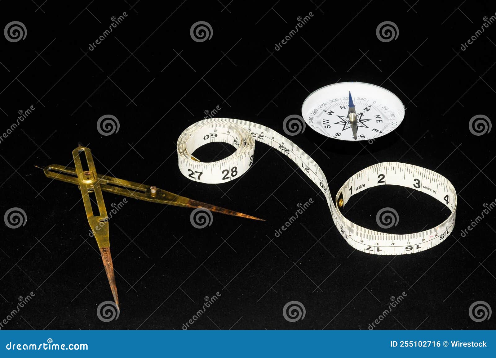 Compass, Measuring Tape, and an Old Brass Reduction Compass on a Black ...