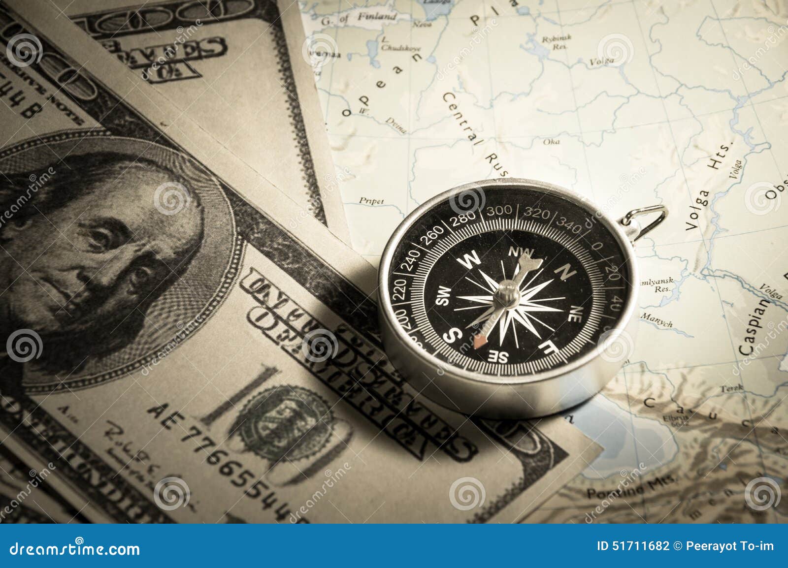 Compass with money on map. stock photo. Image of discovery - 51711682