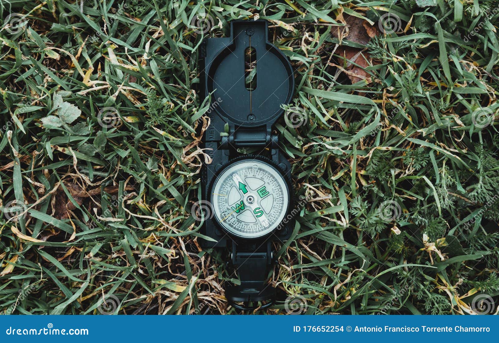 Compass Over Ground and Grass Stock Photo - Image of environmental ...