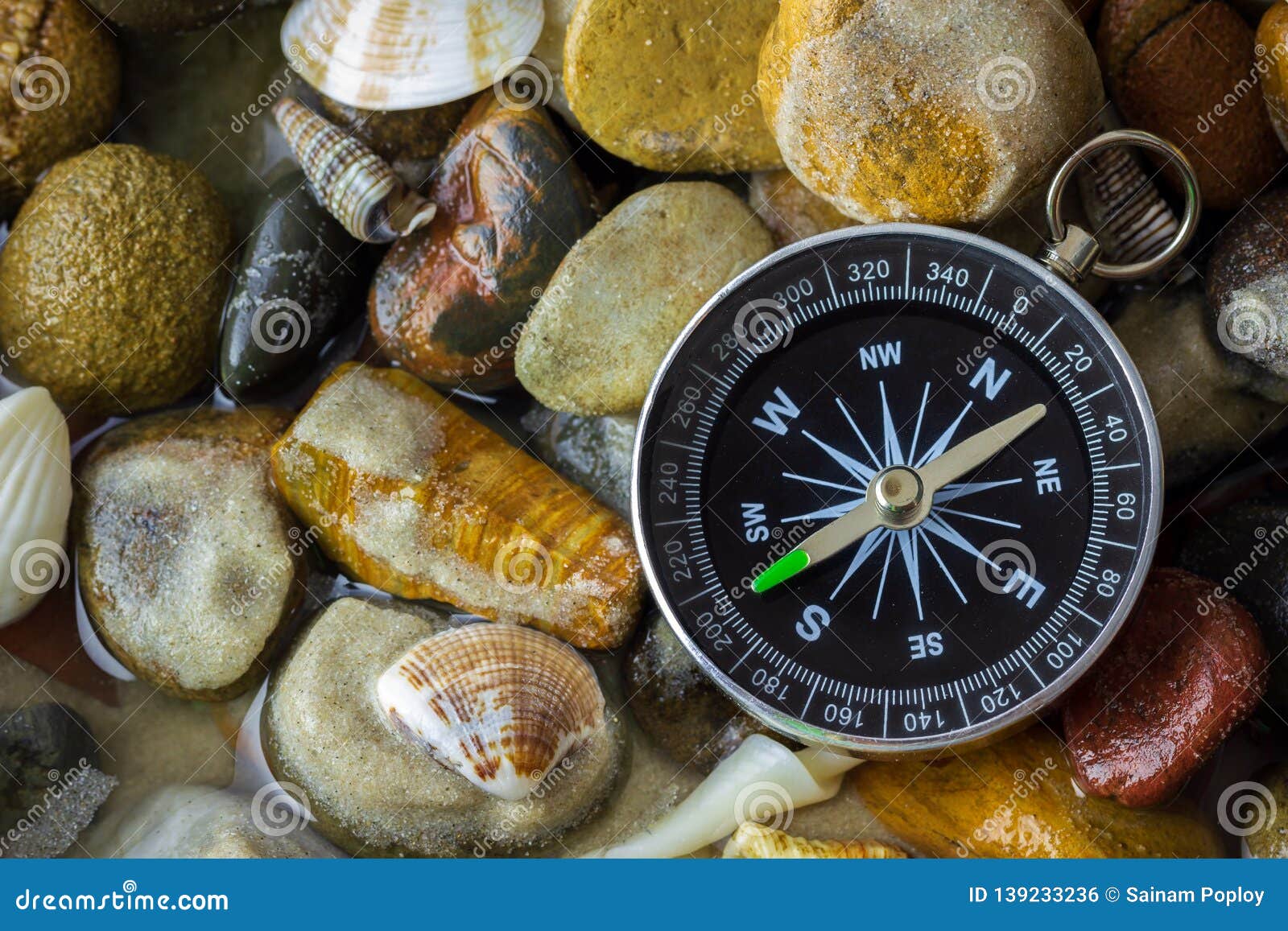 Compass on the Pebbles and Shell at Riverside. Stock Photo - Image of ...