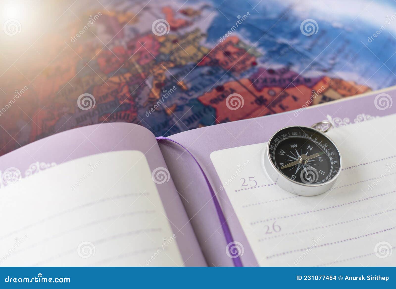 A Compass Placed on a Notebook on the Map Background Stock Photo ...