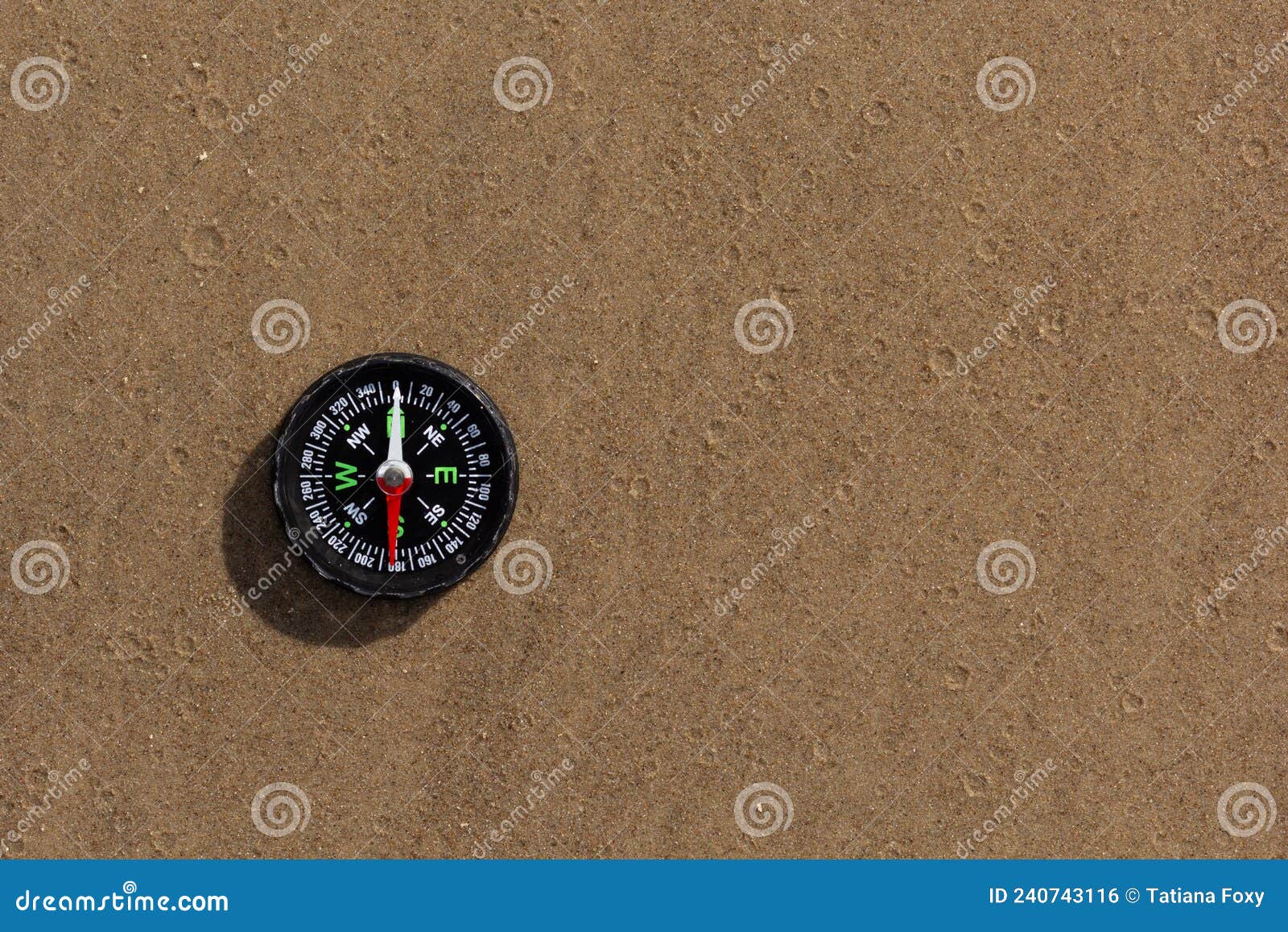 Compass Pointing South Laying on Sand Beach Stock Photo - Image of ...