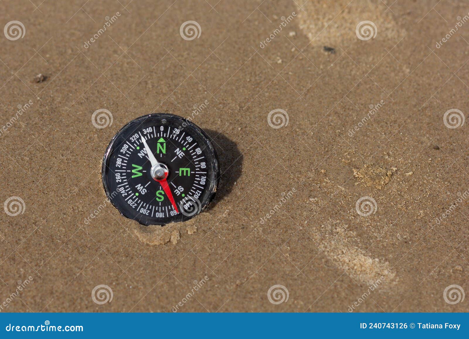 Compass Pointing SouthWest Laying on Sand Beach Stock Photo - Image of ...
