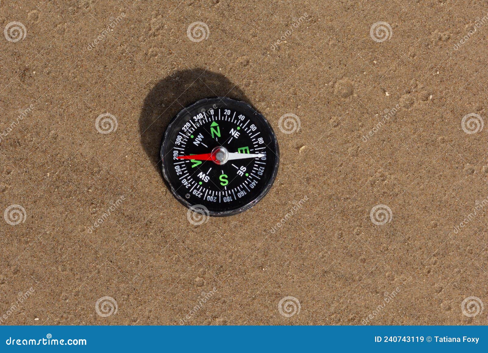 Compass Pointing West Laying on Sand Beach Stock Image - Image of arrow ...