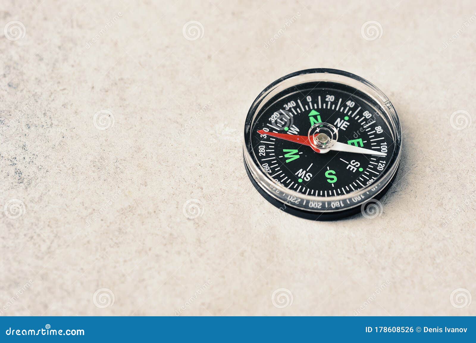 Compass with a Red Magnetic Arrow on a Gray Background with Space for ...