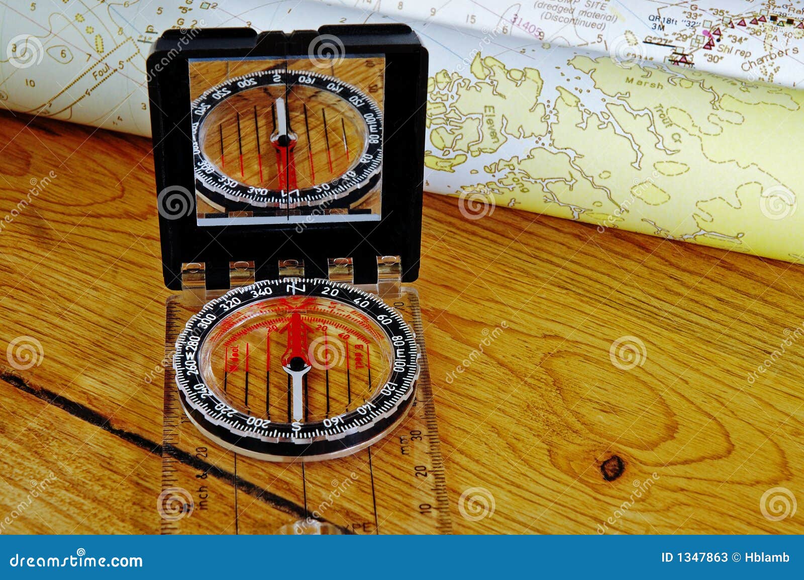 Compass with rolled map stock image. Image of needle, table - 1347863