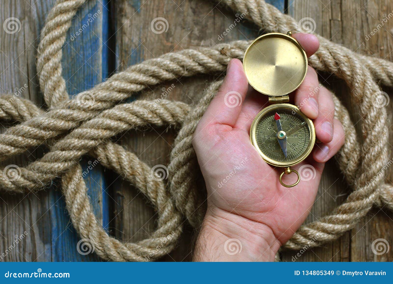 Compass In Sailor Hand Nautical Background With Weathered Deck And Rope Stock Image Image Of