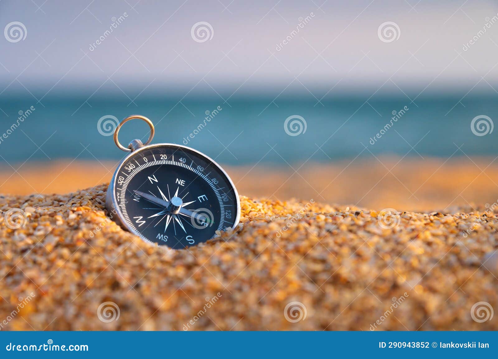 Compass on the Sand Close-up, Sea in the Background in Sunset Light ...