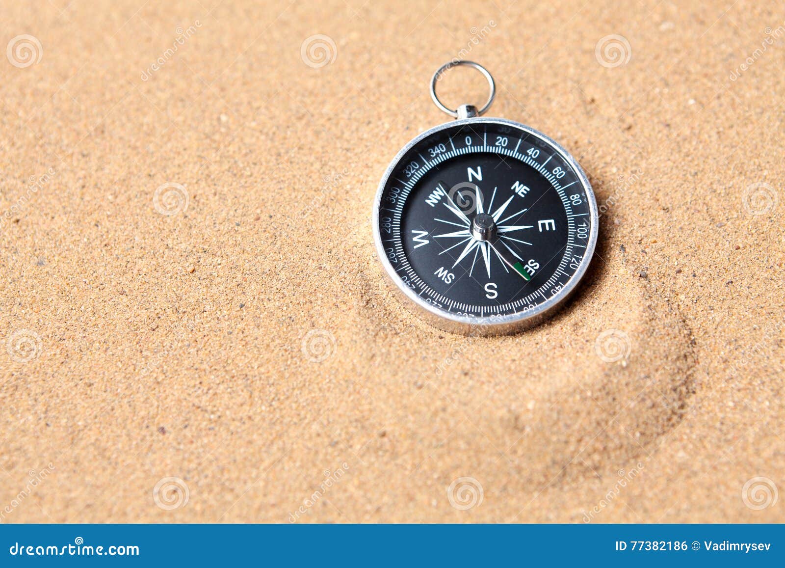 Compass on the sea sand stock photo. Image of instrument - 77382186